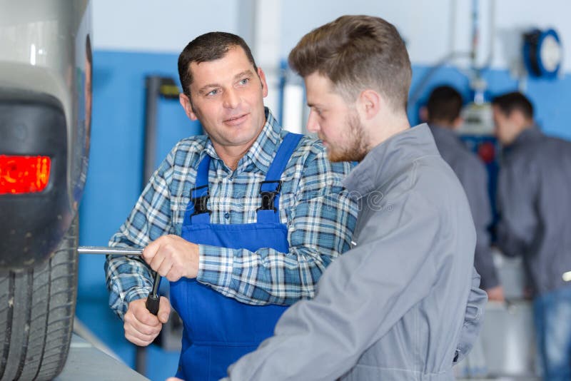 Demonstrating on How To Remove Tire Stock Photo - Image of mechanic ...