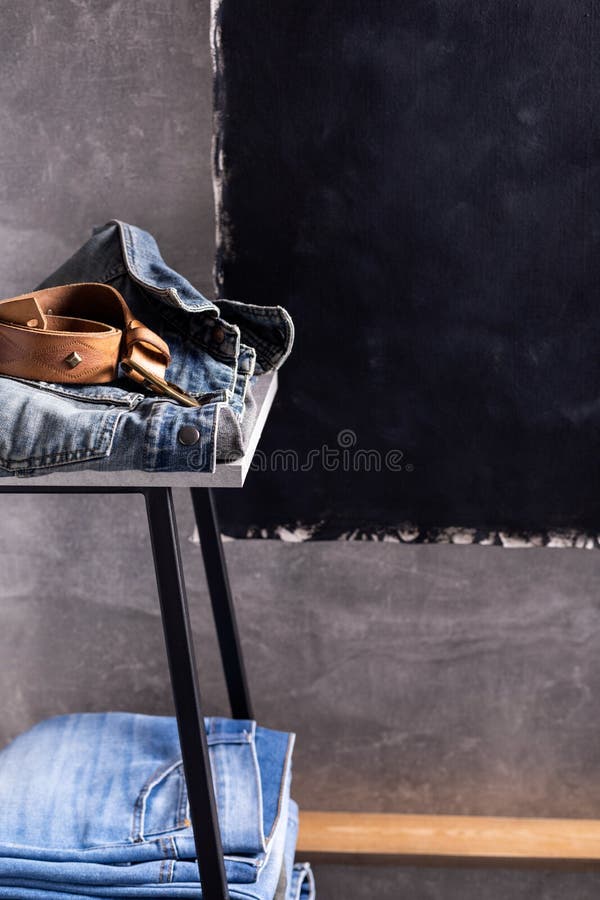Denim Jeans and Leather Belt at Stool. Stack of Jeans Stock Photo ...