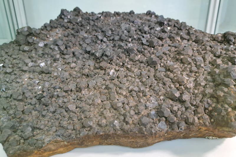 A Dense Cluster of Dark, Metallic Crystals with Sharp, Geometric Edges ...