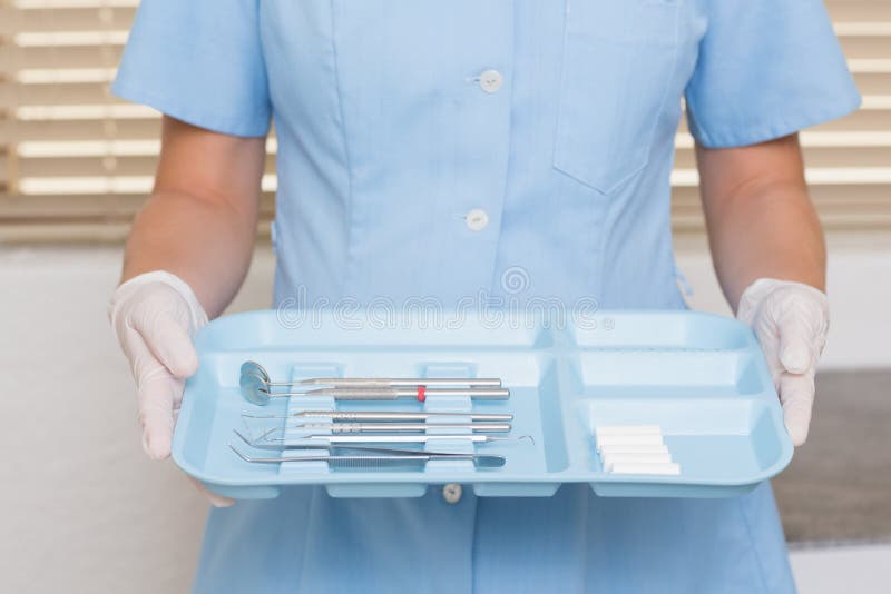 Dental Assistant in Blue Holding Tray of Tools Stock Image - Image of ...