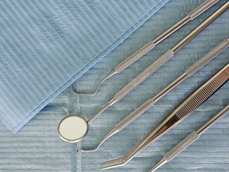 Dental Examination Tools Arranged on a Blue Surface Ready for Use ...
