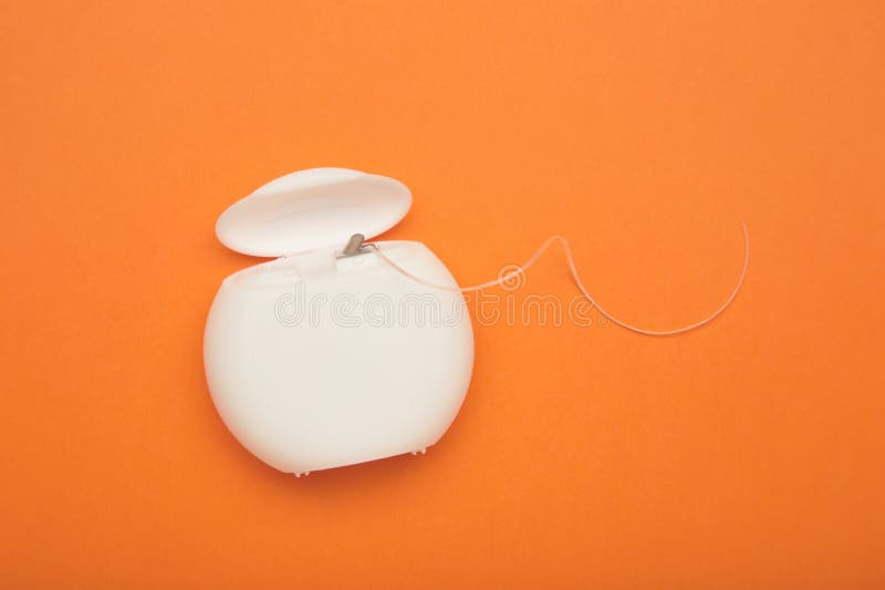 Dental Floss on Orange Background. Space for Text Stock Image - Image ...