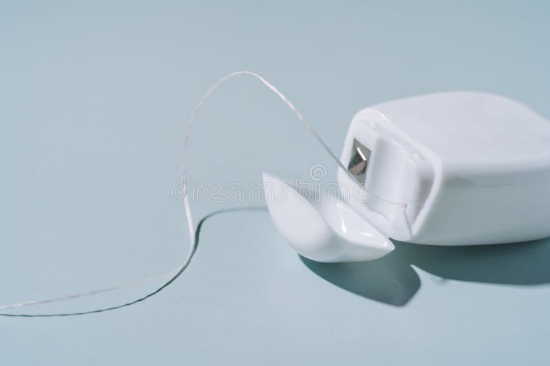Dental Floss in a White Box Close-up on a Blue Background Stock Photo ...