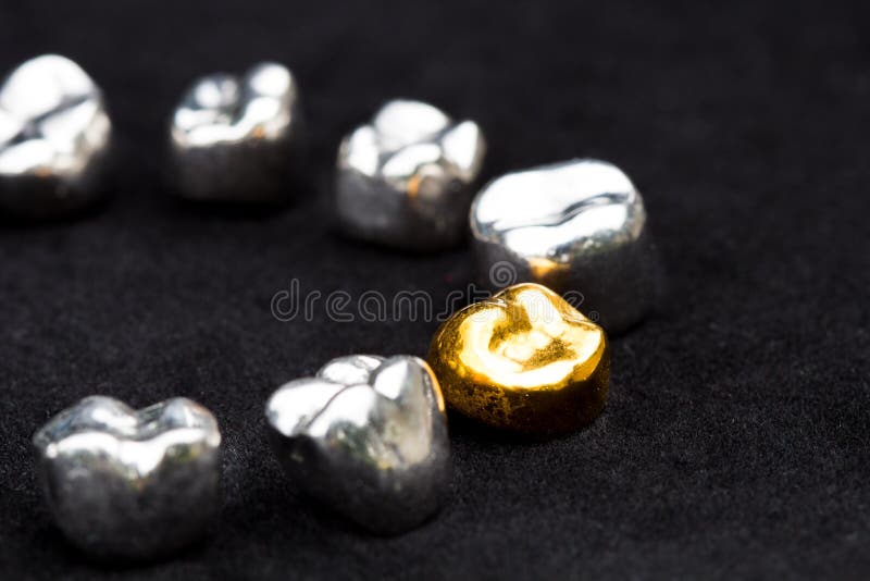 Dental Gold and Metal Tooth Crowns on Dark Black Surface. Stock Photo ...