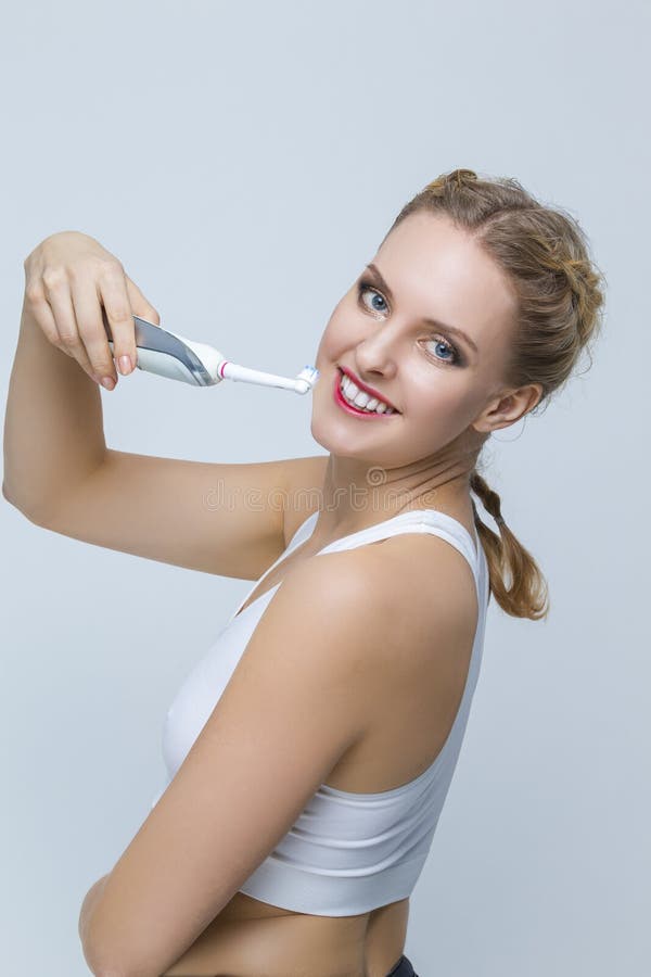 Dental Healthcare Smiling Caucasian Blond Woman In Bra Cleaning Teeth