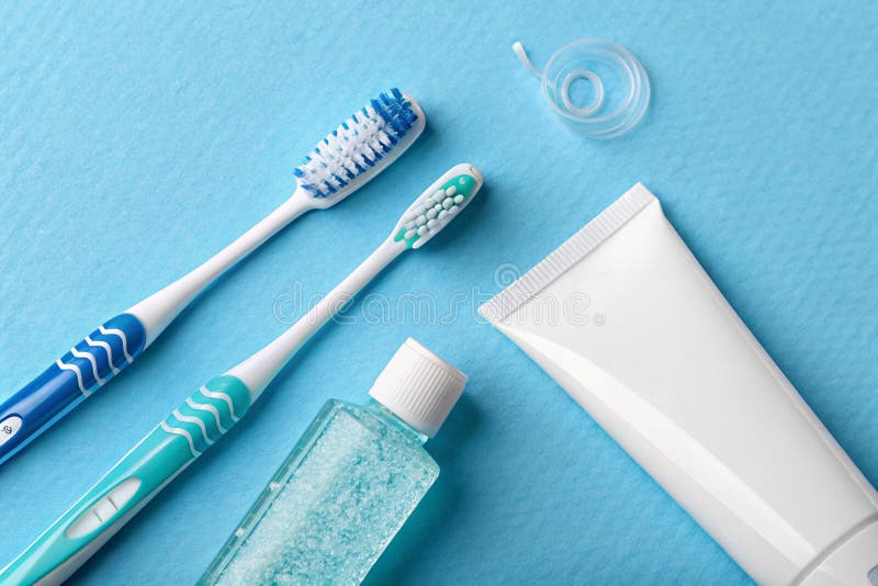 Dental Hygiene Essentials: Two Toothbrushes and Toothpaste on Bright ...