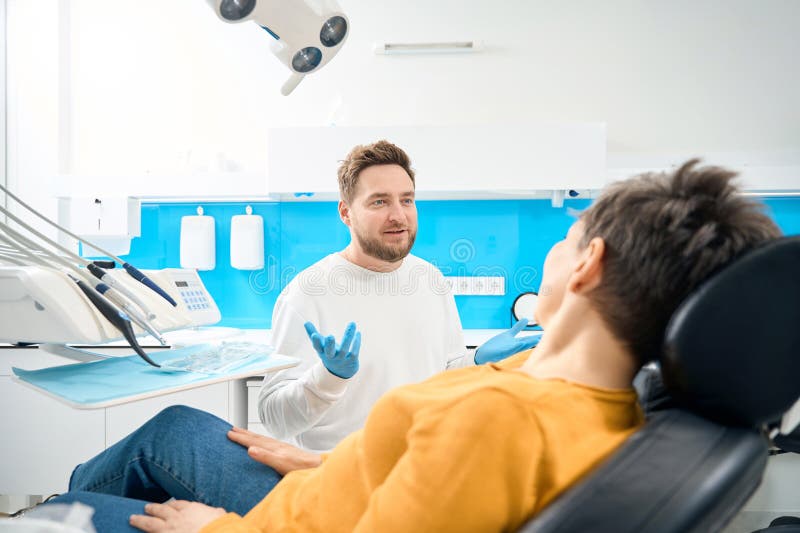 Dental Practitioner Explaining To Client Ways Of Tooth Infection Treatment Stock Image Image