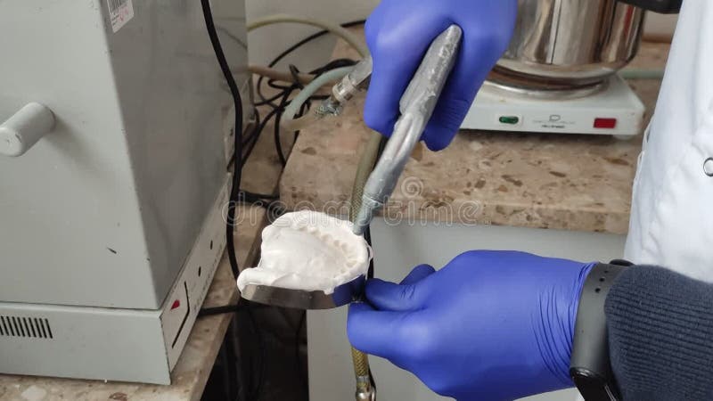 Dental Technician Dries a Cast of Teeth in His Hand Stock Footage ...