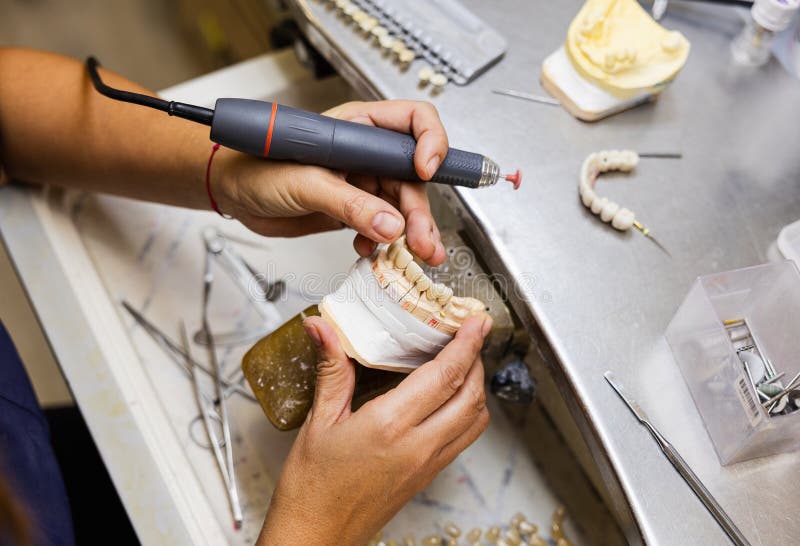 Dental Technician Shaping Prosthetic Teeth with Rotary Tool Stock Photo ...