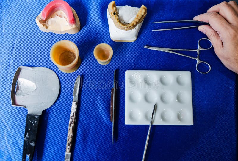 Dental Tools and Prosthetic Molds on a Blue Workspace Stock Image ...