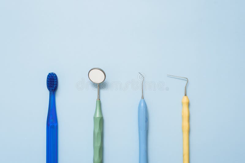 Dental Tools and Toothbrush on a Blue Background. Dental Care Concept ...