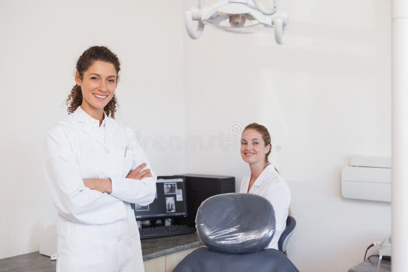 Dentist and Assistant Smiling at Camera Stock Photo - Image of ...