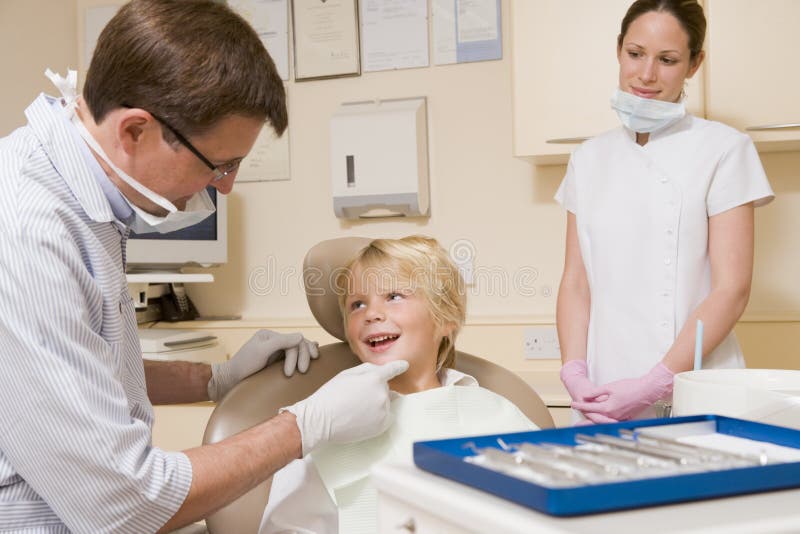 Dentist and Assistant with Young Boy Stock Photo - Image of exam ...