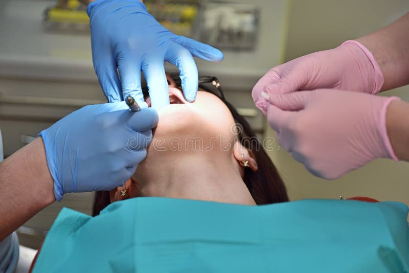 Dentist Conducting an Operation Stock Image - Image of mirror, medicine ...