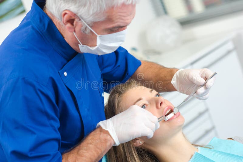 Dentist Curing Female Patient Stock Photo - Image of uniform, dentistry ...