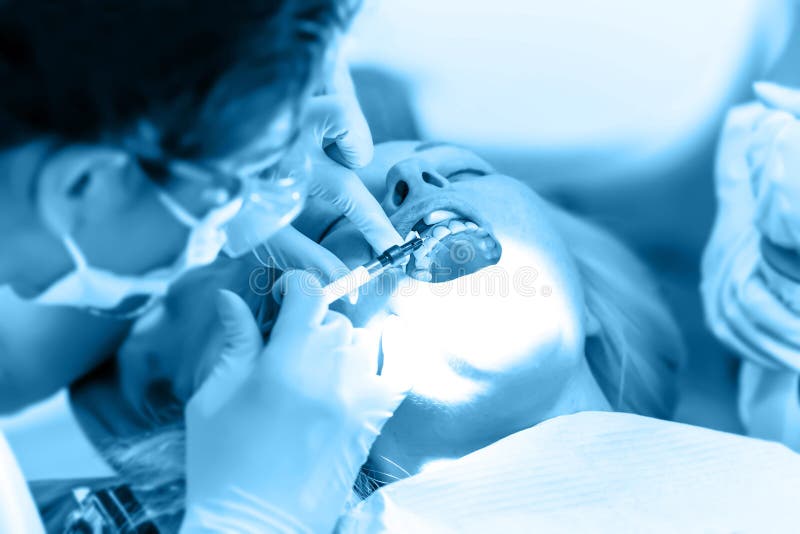 Dentist Curing a Female Patient Stock Image - Image of adult ...
