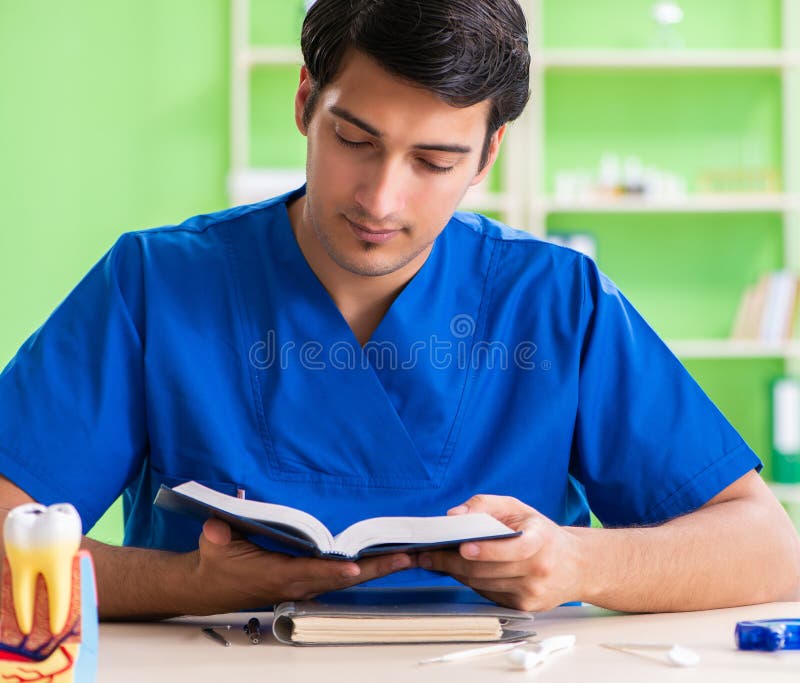 Dentist Doctor Reading Book in the Clinic Stock Photo - Image of clinic ...