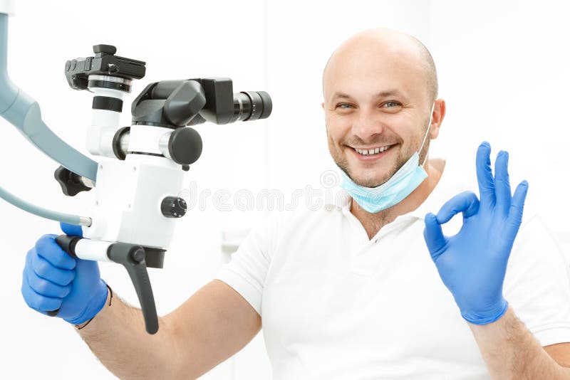 Dentist Doing Fine Sign Near the Dental Microscope Stock Image - Image ...