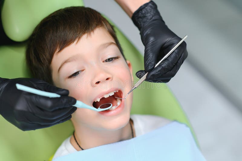 Dentist Examining Little Boy S Teeth in Clinic Stock Photo - Image of ...
