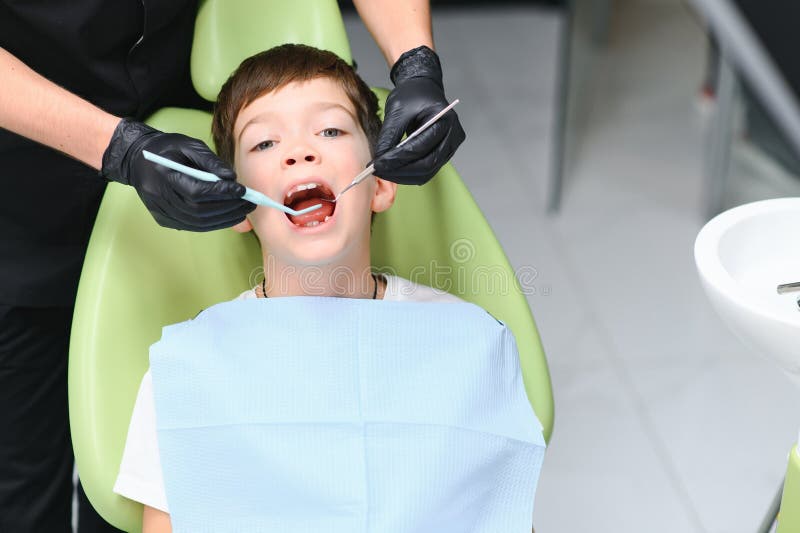 Dentist Examining Little Boy S Teeth in Clinic Stock Image - Image of ...