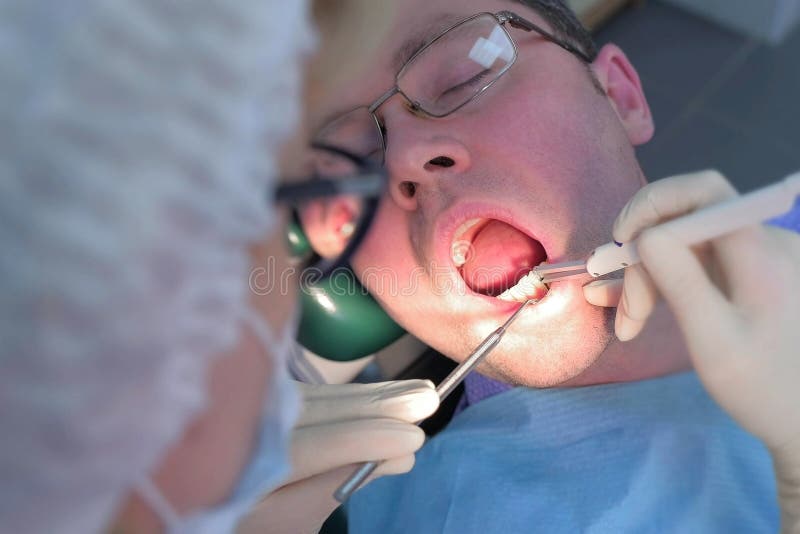 Dentist Examining Patient Gums with Probe Using Method of Computer ...