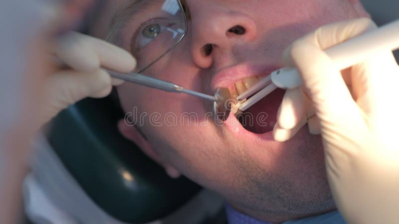 Dentist Examining Patient Gums with Probe Using Method of Computer ...