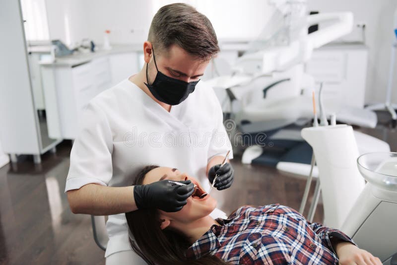 Dentist Examining a Patient`s Teeth in the Dentist Stock Image - Image ...