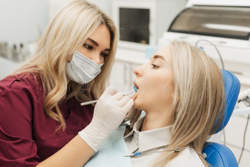 Dentist Examining a Patient S Teeth in the Dentist. Stock Photo - Image ...