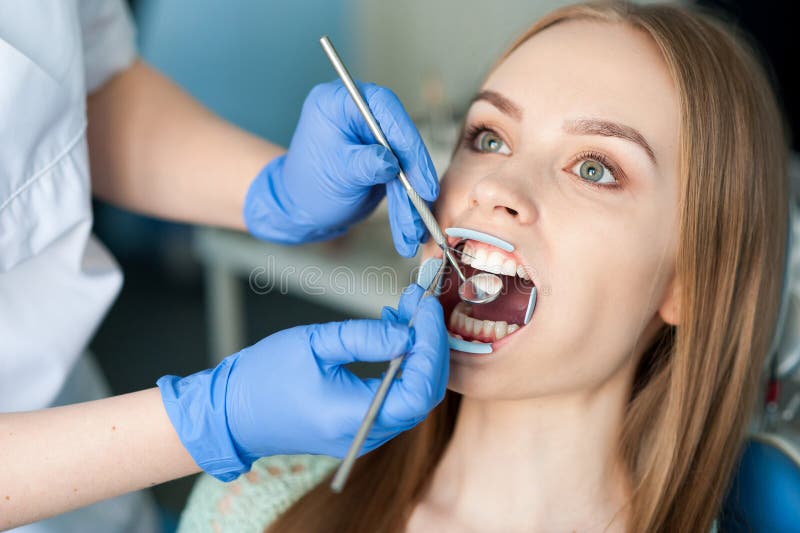 Dentist Examining a Patient`s Teeth in the Dental Clinic. Stock Photo ...