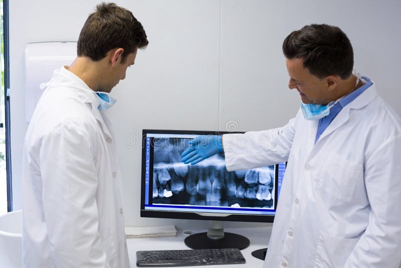 Dentist Examining X-ray Report on Computer Stock Image - Image of ...
