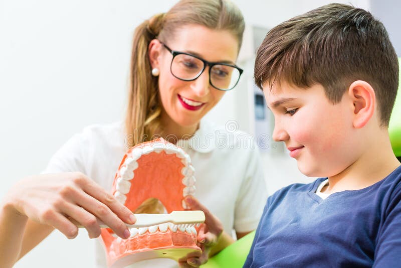 Dentist Explaining Boy Cleaning Tooth Stock Image - Image of showing ...