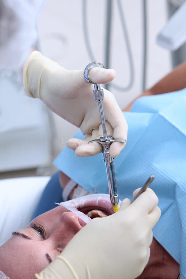 The Dentist Gives An Injection Of Anesthetic Hands In Rubber Gloves