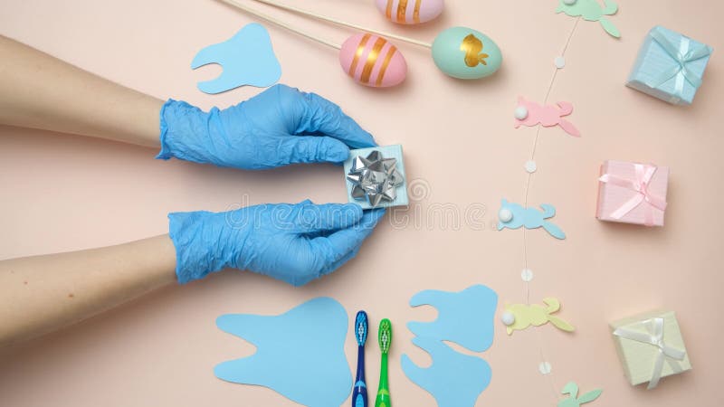 Dentist Hands Holding Gift on Easter Day, Top View. Stock Video - Video ...