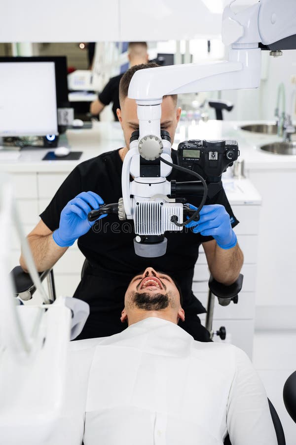 Dentist is Looking on Teeth Condition by Surgical Digital Microscope in ...