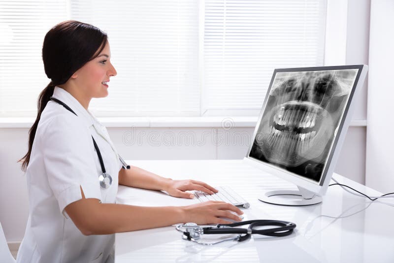Dentist Looking at Teeth X-ray on Computer Stock Image - Image of ...