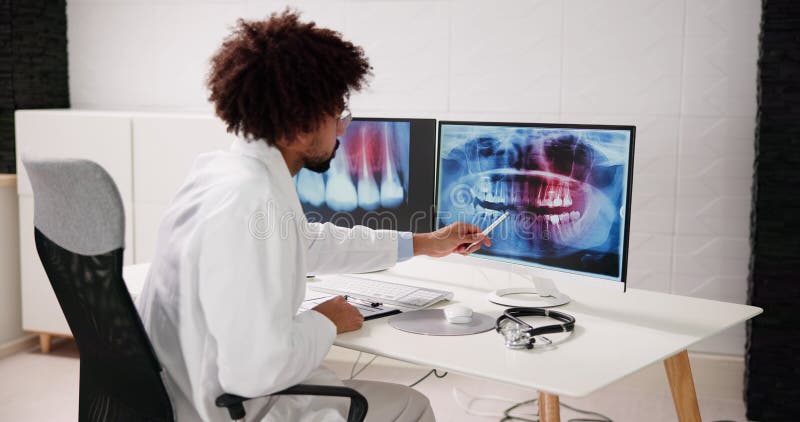 Dentist Looking at Teeth Xray Scan Stock Photo - Image of african ...