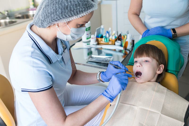 Dentist and Nurse Curing Childe Teeth Stock Image - Image of check ...