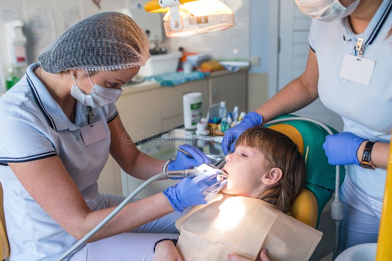 Dentist and Nurse Curing Childe Teeth Stock Image - Image of dentist ...