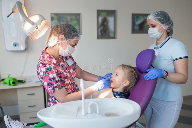 Dentist and Nurse Curing Childe Teeth Stock Photo - Image of dentist ...