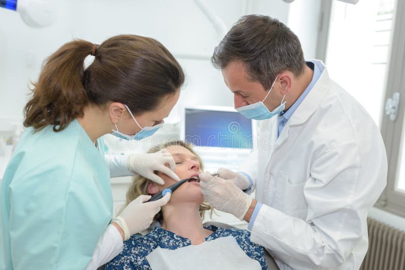 Dentist and Nurse Curing Female Patient Stock Image - Image of nurse ...