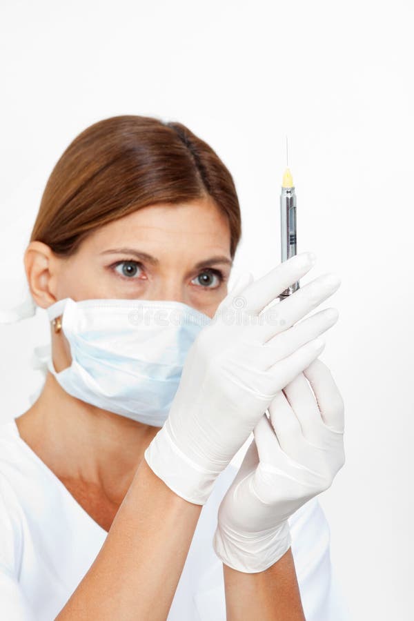 Dentist pulls up syringe stock photo. Image of female - 195689084