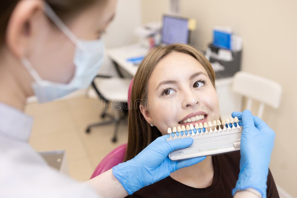 The Dentist Selects the Color of the Enamel. the Dentist Selects a ...