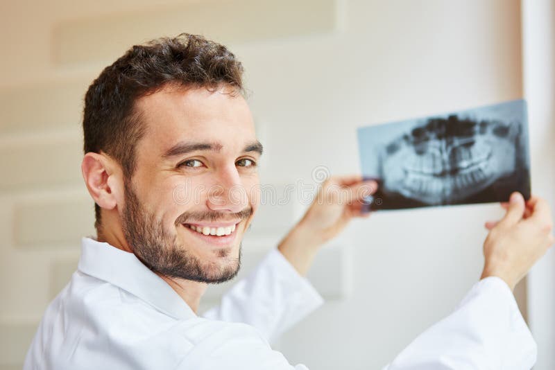 Dentist Smiling and Holding X-ray Stock Image - Image of people ...