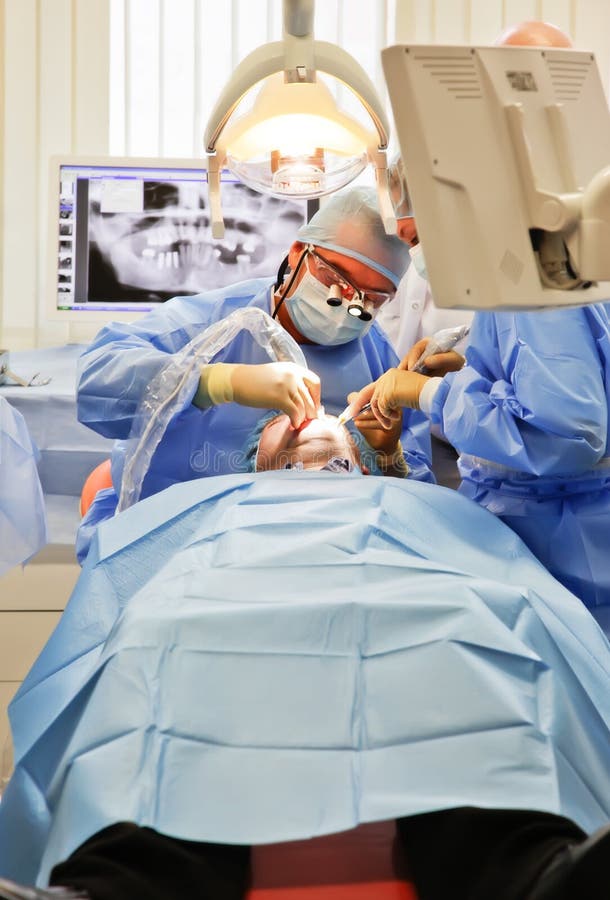 Dentist team at work stock image. Image of seat, indoors - 21450335
