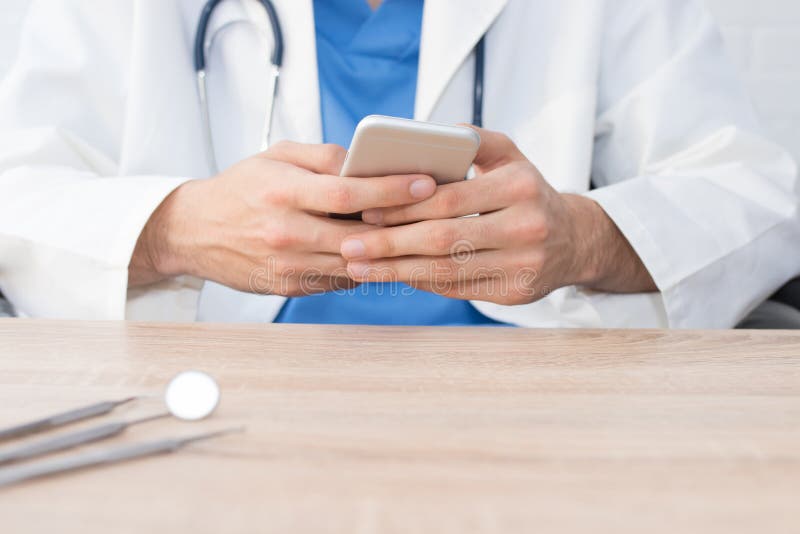 Dentist with smartphone stock image. Image of beauty - 161748309