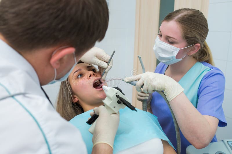Dentist Treating Patients Teeth with Special Instruments Stock Photo ...