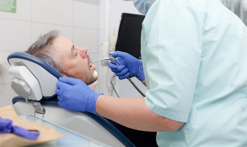 The Dentist Treats the Patient`s Sick Teeth. Stock Image - Image of ...