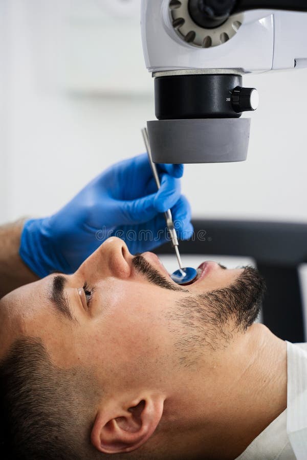 Dentist Uses Operating Microscope To Polish Teeth of the Patient ...