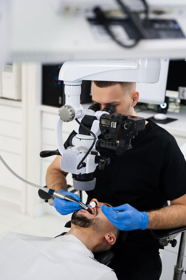 Dentist Uses Operating Microscope To Polish Teeth of the Patient ...