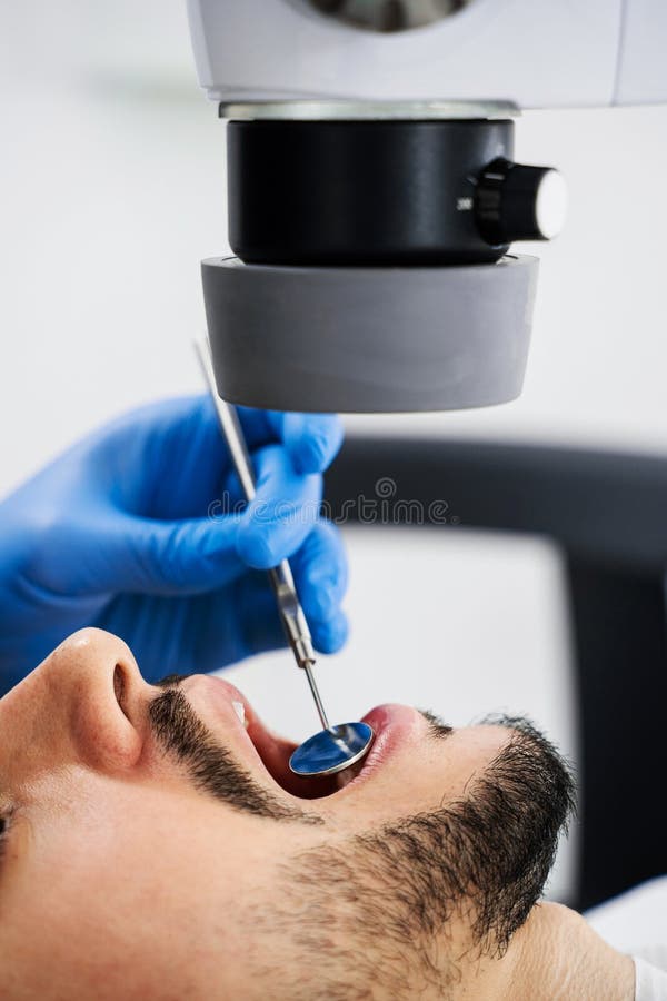 Dentist Uses Operating Microscope To Polish Teeth of the Patient ...